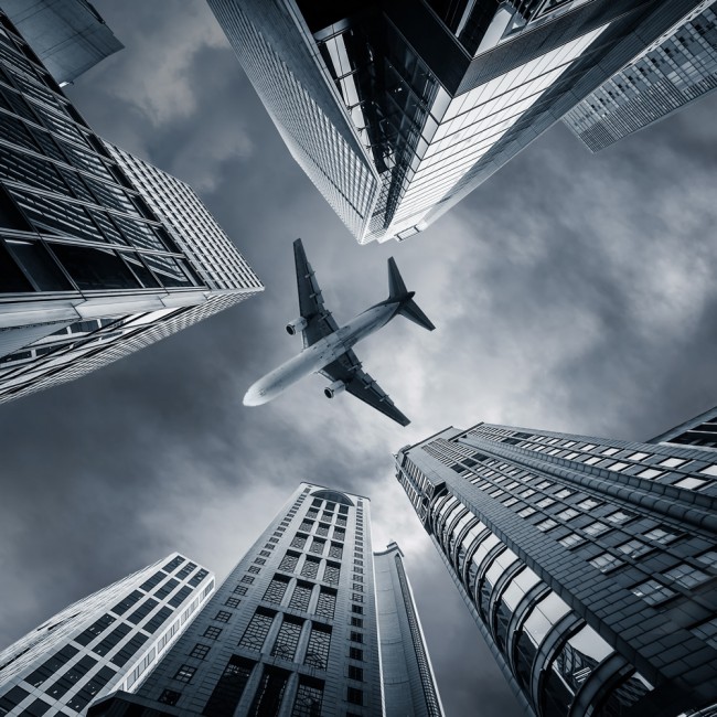 Airplane & City Skyscrapers Wallpaper Wall Mural